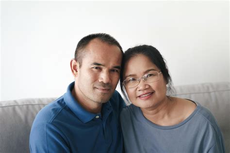 Portrait Of Asian Mature Couple Sitting In The Living Room Wife And