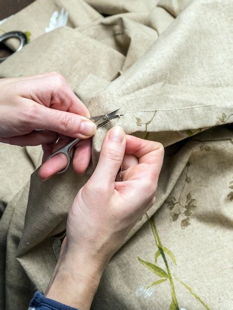Premium Photo High Angle View Of Woman Cutting Thread On Textile