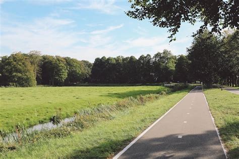 Premium Photo Road Passing Through Field