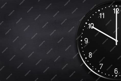 Premium Photo Closeup Of Black Wall Clock On Black Chalkboard Background