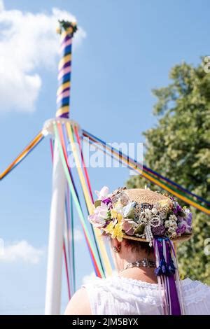 A Vertical Shot Of A Traditional English Maypole Dancer With A Floral