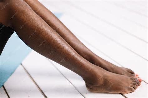 Premium Photo Bare Legs Of Afro American Woman Closeup White Floor
