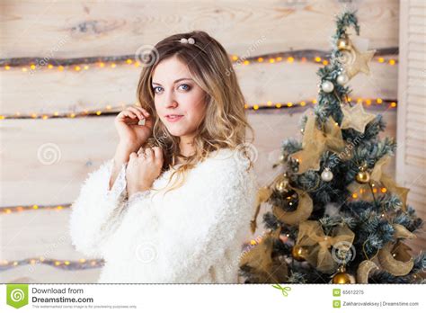 Beautiful Girl In White Dress Sitting Near A Beautiful Tree Stock Image