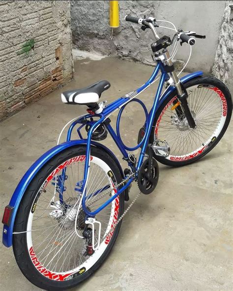 Two Blue Bicycles Parked Next To Each Other