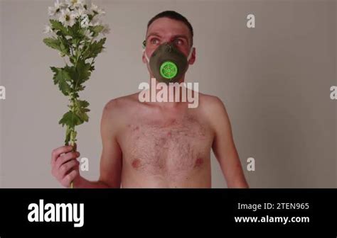 A Faceless Shirtless Man In A Gas Mask With Flowers Man With A Naked