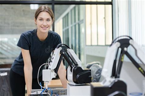 Female Staff Engineer With Robot For Education On Table At Class Room