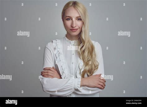 Young And Beautiful Long Haired Blond Woman In White Blouse Standing