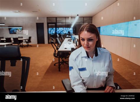 Female Security Operator Working In A Data System Control Room Offices Technical Operator