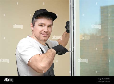 Construction Worker Repairing Window In House Stock Photo Alamy