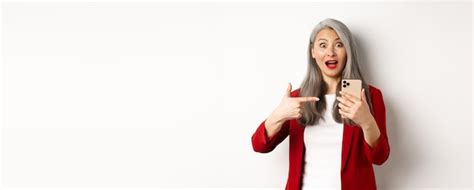 Premium Photo Amazed Asian Lady In Red Blazer Pointing Finger At