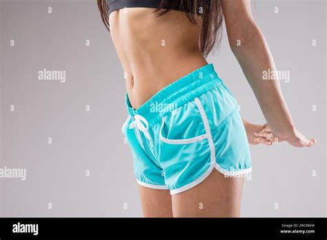 Young Woman Flaunts Her Perfect Midriff Thighs And Buttocks