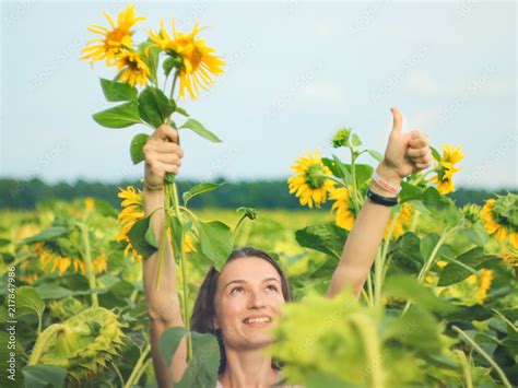 Beautiful Young Woman In The Field Of Sunflowers Hands Up Holding
