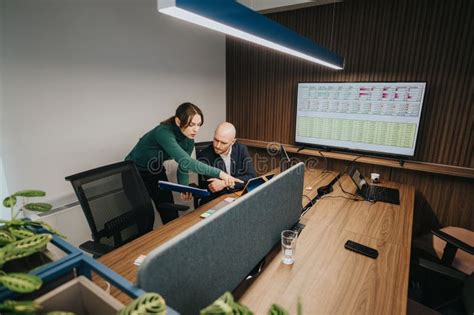 Business Colleagues Analyzing Data Collaboratively In A Modern Office Environment Stock Image