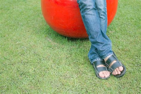 Premium Photo Low Section Of Man Sitting On Grass