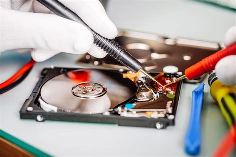 Premium Photo Man Repairing Hard Drive In Service Center Repairing And Fixing Service In Lab