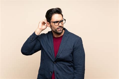 Premium Photo Handsome Young Man Over Isolated Wall With Confuse Face Expression