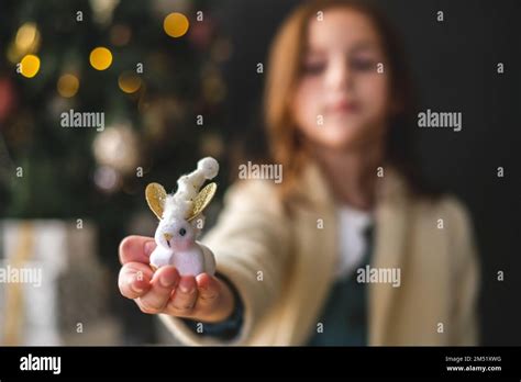 A Cute Girl Holds Out A Toy Rabbit On Her Arm Symbol Of 2023 Stock