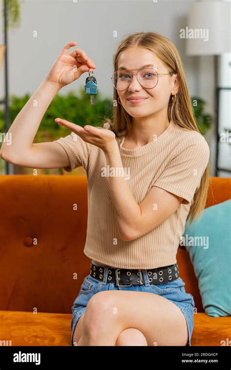 Blonde Woman Real Estate Agent Lifting Hand Showing The Keys Of New