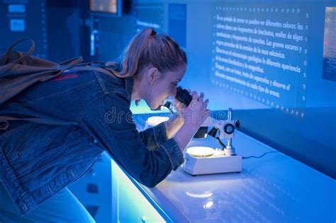 Girl Looking Through Microscope In Science Lab Stock Image Image Of Crouching Girl 283866361