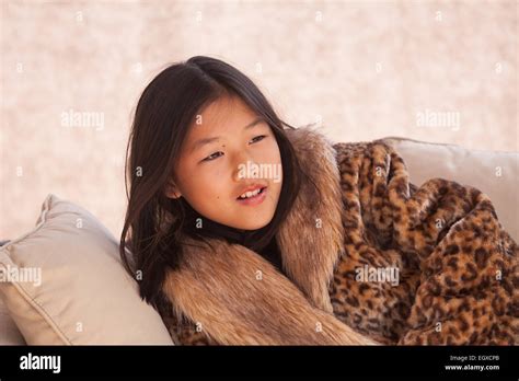 Beautiful Chinese Girl Dressed With An Ethnic Coat Posing And Playing