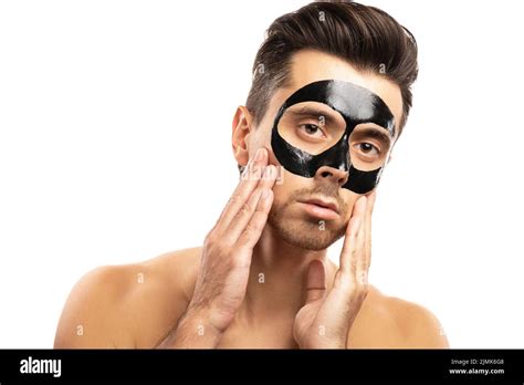 Young Guy With A Black Charcoal Mask On His Face On White Background