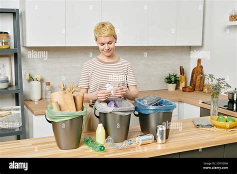 Pretty Female Sorting Various Kinds Of Trash Into Three Bins Stock Photo Alamy