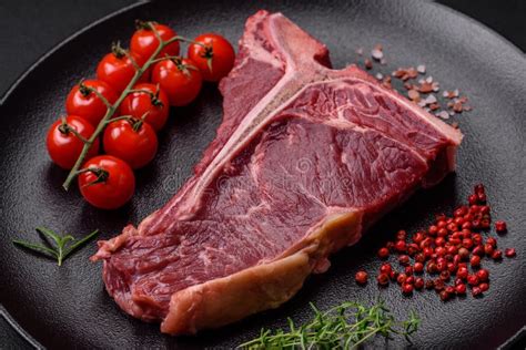 Raw Juicy Beef T Bone Steak With Salt Spices And Herbs Stock Image