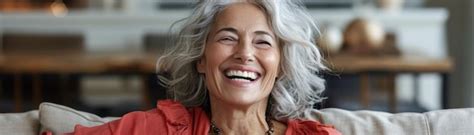 Joyful Older Woman With White Teeth Relaxing At Home Premium Ai