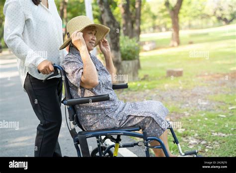Caregiver Help And Care Asian Senior Or Elderly Old Lady Woman Patient