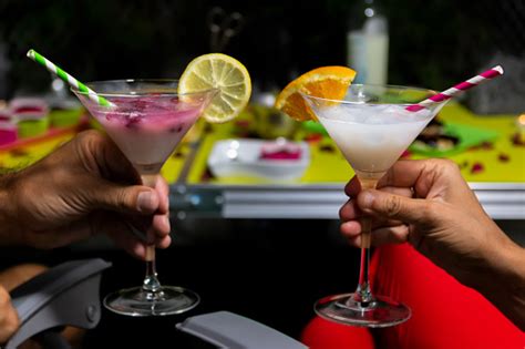 Spouses Celebrating Anniversary With Cocktail In Triangular Drinking
