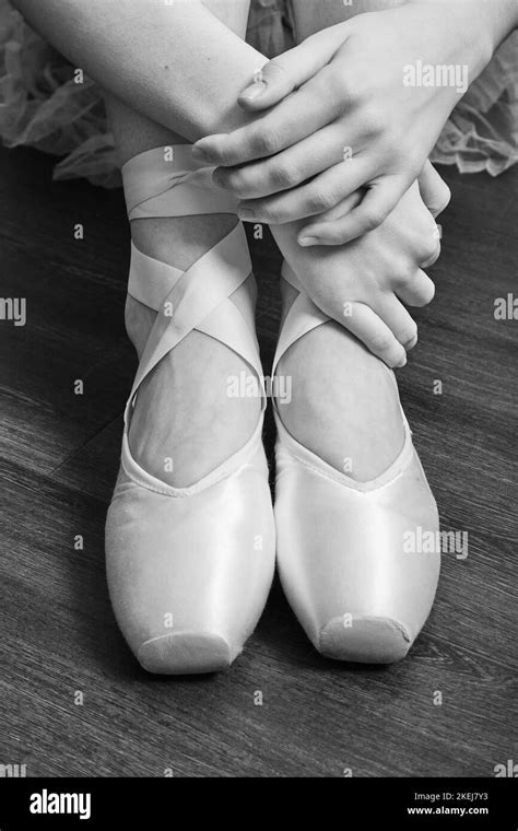 Female Ballerina Feet In Pointes On A Wooden Floor Closeup Monochrome