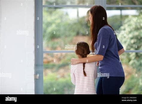 Special Moments With Mom Rearview Shot Of A Loving Mother And Daughter Looking Out The Window