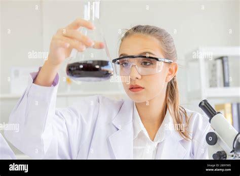 A Beautiful Female Scientist Is Operating In A Science Lab With Various