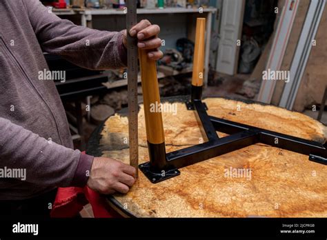 Closeup Of Person Measuring The Distance Of A Table Leg With An Iron Ruler Stock Photo Alamy