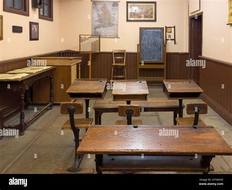Castle Museum Recreation Of An Austere Victorian Classroom Featuring Wooden Desks With Ink