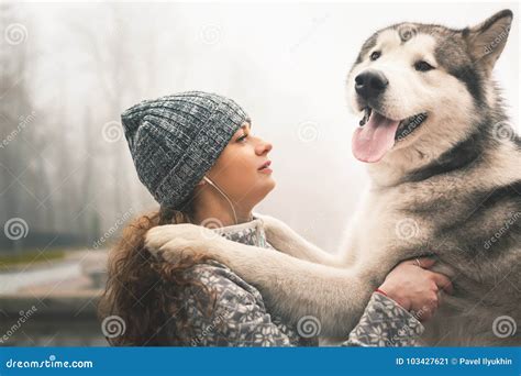 Image Of Young Girl With Her Dog Alaskan Malamute Outdoor Stock Image