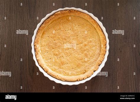 A Blind Baked Shortcrust Pastry Case In A White Ceramic Flan Tin