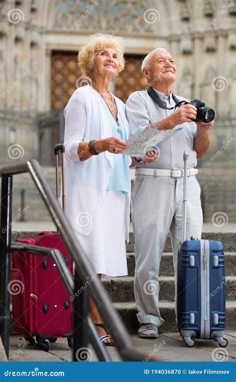 Mature Couple Making Photo And Using Map During Joint Vacation Stock