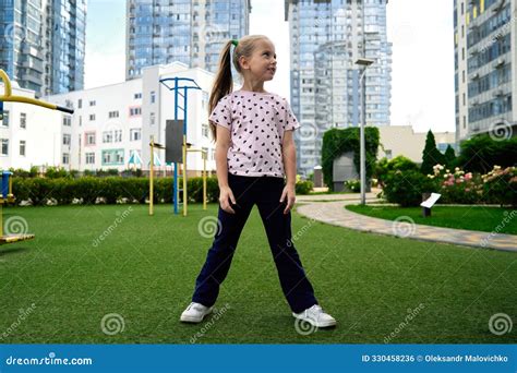 Young Girl Playing In A Modern Urban Playground On A Sunny Day