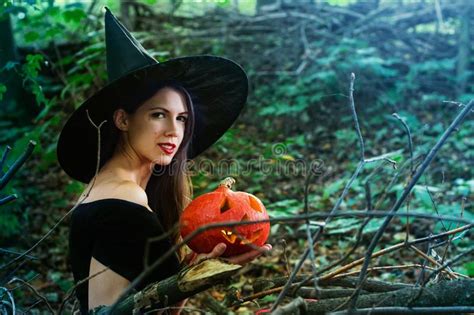 Young Pretty Woman In Witch`s Hat Holding Halloween Pumpkin Jack Stock