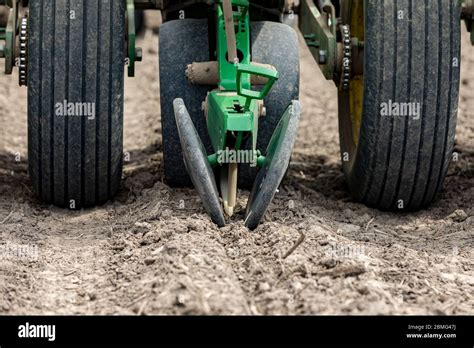 Closeup Of Planter In Farm Field Planting Corn Or Soybean Seed In Dry