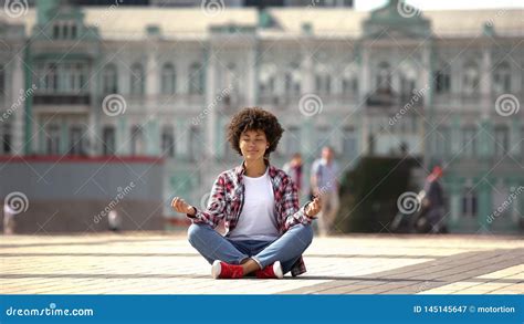 Beautiful African American Woman Practicing Yoga In City Center
