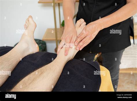 Woman Hands Doing Calf Massage Of Man Legs In Cosmetology Spa