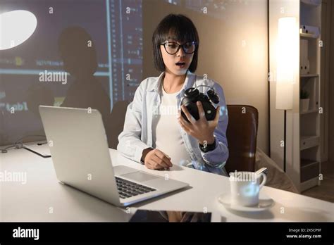 Shocked Female Programmer With Alarm Clock In Office At Night Stock
