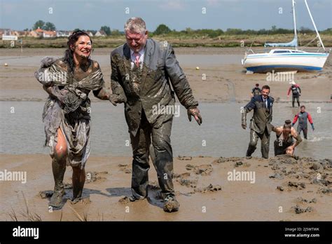 Recently Married Couple In Their Wedding Attire Covered In Mud After