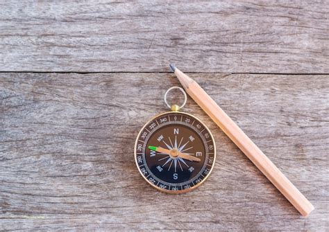 Premium Photo Pencil And Compass Over A Wooden Background