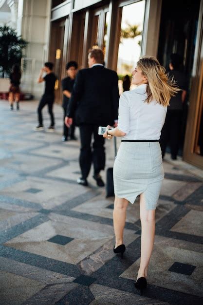 Women Walking On Footpath In City Premium Photo