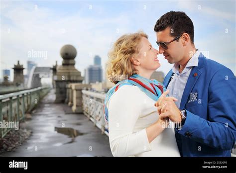 Pregnant Woman In White And Stylish Man Touch Each Other Noses On