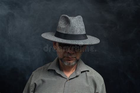 Portrait Of Man With Beard And Sunglasses And Hat Posing For