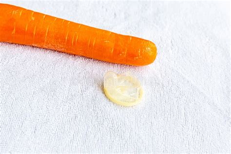 Safe Sex Symbol Set Carrots And Condom Close Up Lies On A White Background Stock Image Image
